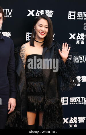 Chinese singer Tan Weiwei arrives for a premiere event of the movie "X ...