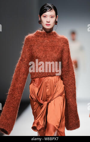 A model displays a new creation at the MAKEMAKE fashion show during the ...