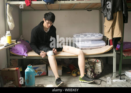 Legless Chinese man Shen Dacheng shows his muscles during a training ...