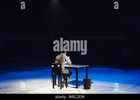 Concept. A lone Office worker sits in a dark room Stock Photo - Alamy