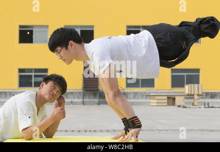 Legless Chinese man Shen Dacheng shows his muscles during a training ...