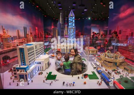 Visitors look at Shanghai's landmark buildings made with Lego bricks at ...