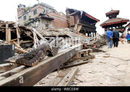 People walk past debris in the Kaweni slum Thursday, Dec. 19, 2024, on ...