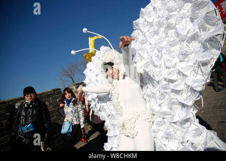 Chinese artist Kong Ning, right, dressed in a butterfly costume made ...