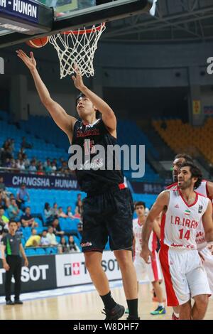 Joji Takeuchi of Japan drives to the basket against Qatar in a quarter ...
