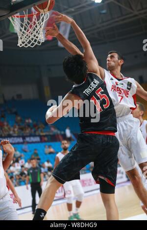 Joji Takeuchi of Japan, right, challenges Mohd Mohamed of Qatar in a ...