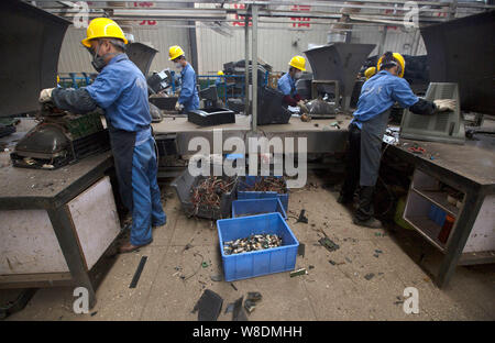 Chinese workers disassemble tube television sets in a plant at the ...