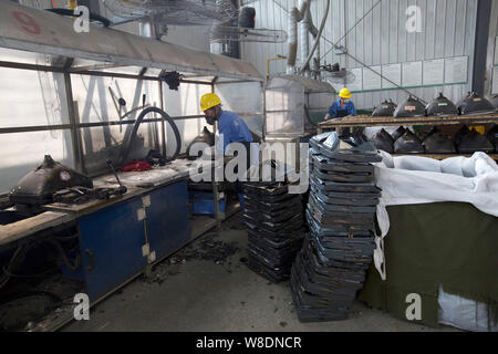 Chinese workers disassemble tube television sets in a plant at the ...