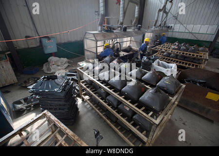 Chinese workers disassemble tube television sets in a plant at the ...