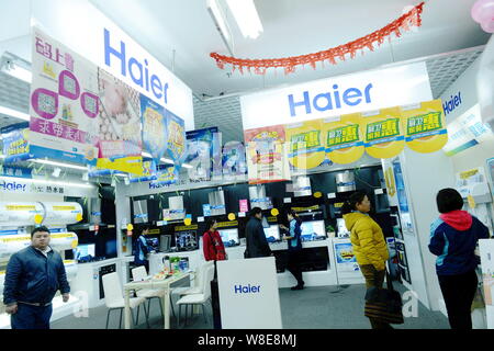 --FILE--Chinese customers shop for Haier LCD televisions at a household appliances store in ...