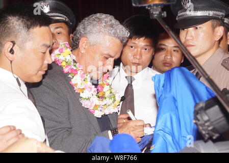 Retired Italian football star Roberto Baggio, center, signs for fans ...