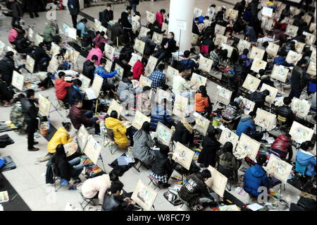 Chinese candidates are drawing as they take part in the entrance ...
