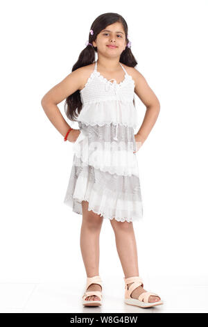 Girl with arms akimbo standing on rock in forest Stock Photo - Alamy