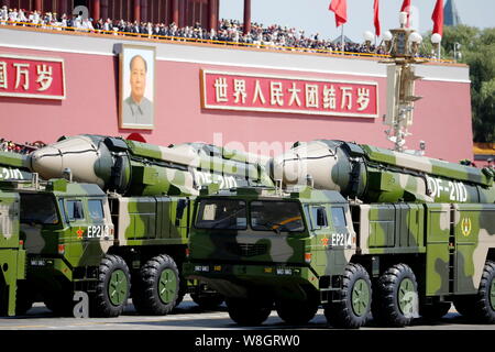Military vehicles carrying DF-21D anti-ship ballistic missiles march ...