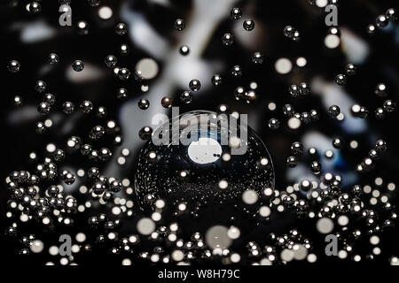 Closeup shot of small steel balls on a wooden surface Stock Photo - Alamy