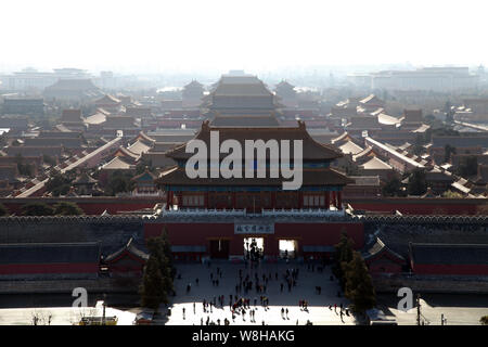 Tourists visit the Palace Museum in heavy rain in Beijing, China, 19 ...