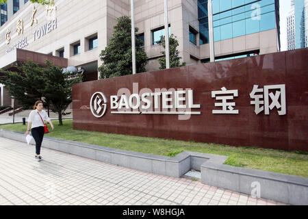 --FILE--A pedestrian walks past the Baosteel Tower in Shanghai, China ...