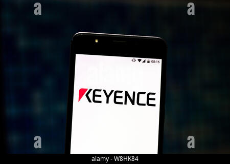In this photo illustration a Keyence logo seen displayed on a ...