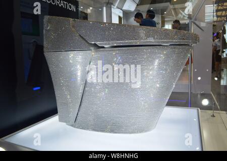 A flush toilet decorated with 72,000 Swarovski crystals is on display ...