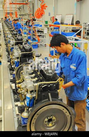 --FILE--Chinese workers assemble engines for autos at a plant of ...