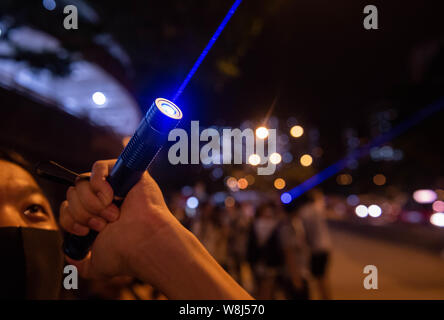 Protester use blue laser pointers against the riot police officers and ...