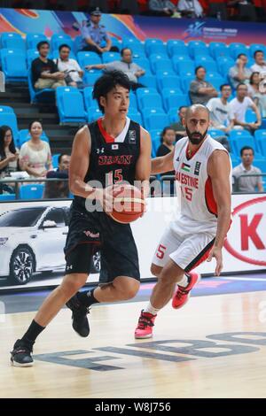 Joji Takeuchi of Japan, right, challenges Mohd Mohamed of Qatar in a ...