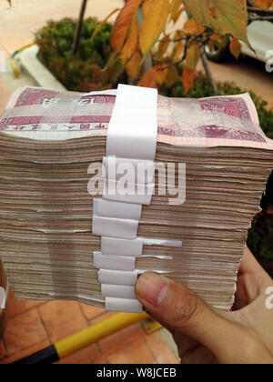 Part of Chinese yuan renminbi banknotes with words in Chinese which ...