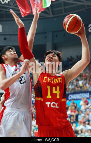Zhelin Wang (L) of China men basketball team and Wengyen Gabriel (R) of ...