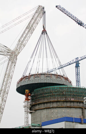 A containment dome for the No.2 reactor is being lifted and installed ...