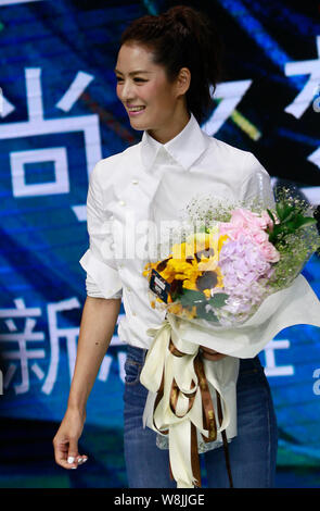 Chinese fashion designer Mary Ma, center, poses with models displaying ...