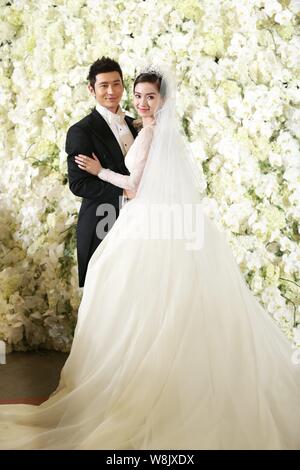 Chinese actor Huang Xiaoming, left, and his actress wife Angelababy ...