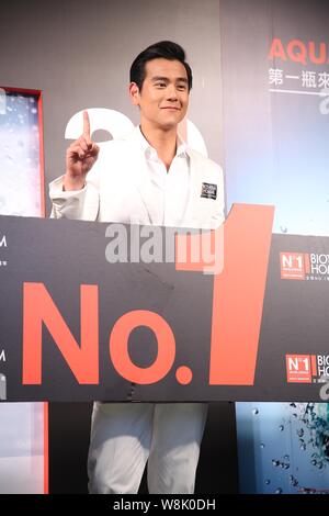 Taiwan actor Eddie Peng, poses with a ink brush as he unveils a movie ...