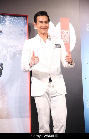 Taiwan actor Eddie Peng, poses with a ink brush as he unveils a movie ...