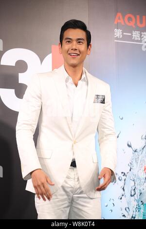 Chinese actor Eddie Peng poses in front of Chinese fans as he arrives ...