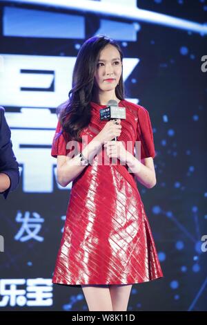 Chinese actress Tang Yan, wearing a Louis Vuitton dress, poses during a ...