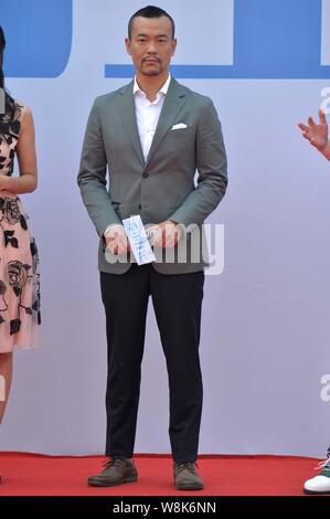 Chinese actor Liao Fan poses on the red carpet of the grand ceremony ...