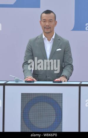 Chinese actor Liao Fan poses on the red carpet of the grand ceremony ...