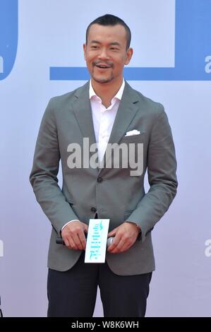 Chinese actor Liao Fan smiles during a press conference for the ...