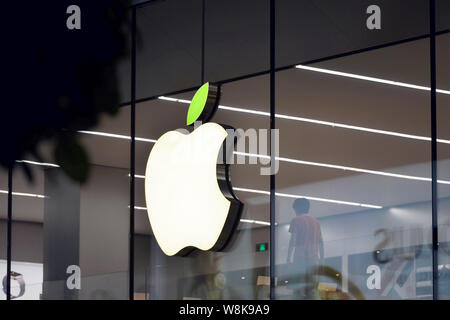 The leaf of the logo of Apple Inc. is illuminated in green at an Apple ...