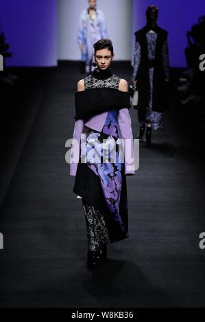 A model displays a new creation at the YUZZO LONDON fashion show during ...