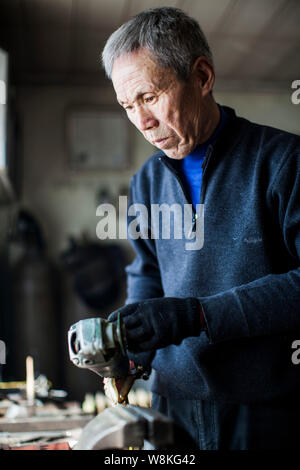 63-year-old armless farmer Sun Jifa, right, who is equipped with his ...