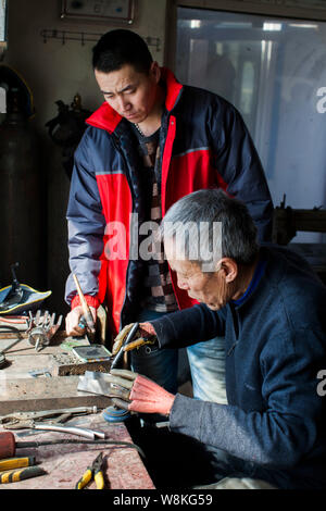 63-year-old armless farmer Sun Jifa, right, who is equipped with his ...