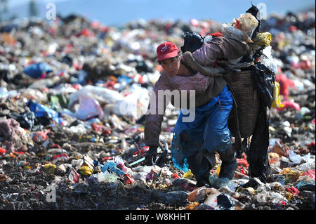 --FILE--A Chinese scavenger searches for useful and recyclable things ...