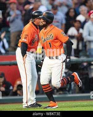 San Francisco Giants third base coach Ron Wotus (23) congratulates ...