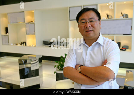 --FILE--Guo Zhiming, Vice President of Joyson Holding, poses during an ...