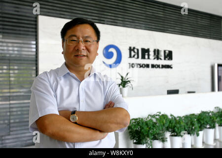 --FILE--Guo Zhiming, Vice President of Joyson Holding, poses during an ...