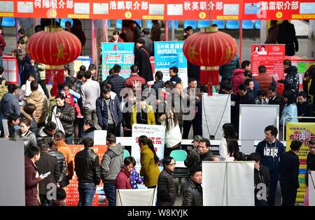 Chinese job seekers look for employments at a job fair in Huaibei city ...