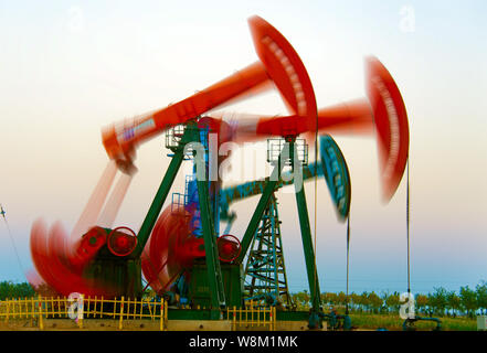 --FILE--Derricks pump crude oil in the Karamay oil field of CNPC (China ...