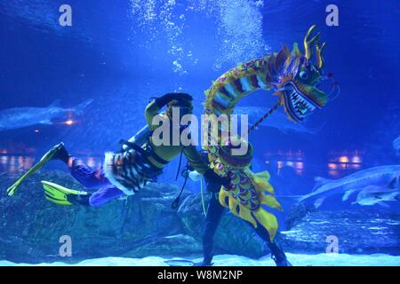 Chinese divers dressed in the diving suits of "Monkey King" and dragon ...