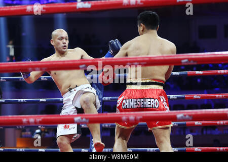 Chinese boxer Wang Hongxiang, right, fights Japanese boxer KING in ...